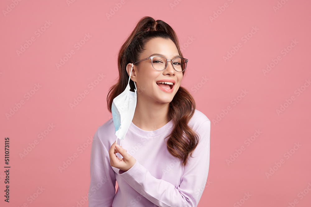 Beautiful young asian girl taking off face mask after the end of ...