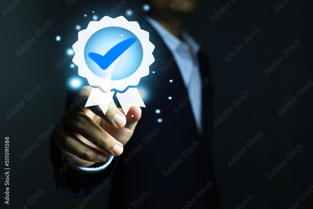 Businessman hand touch to click activates sign of quality assurance ...