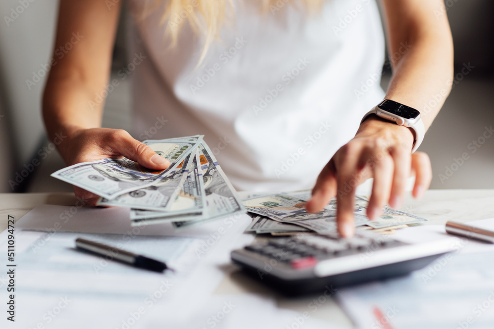 Close up young business woman using counting cash money one hundred ...