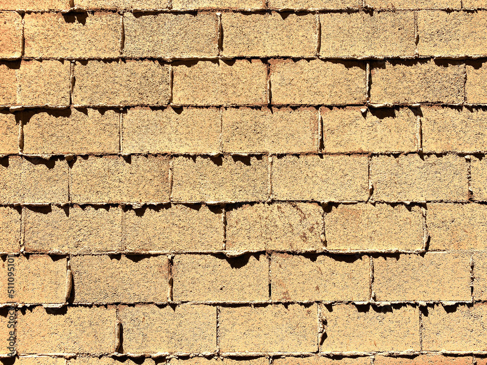 vintage old tan painted alley cinder block brick wall exterior shadows ...
