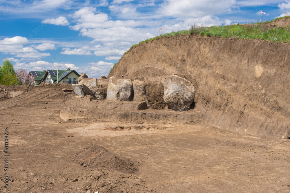Spring landscape with excavations place of granite gravestone plates in ...
