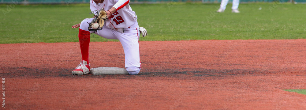 Baseball infielder backhanding the ball over 2nd base Stock Photo ...