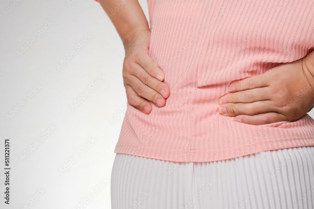 Back view of woman suffering from backache, waist pain, muscle or ...