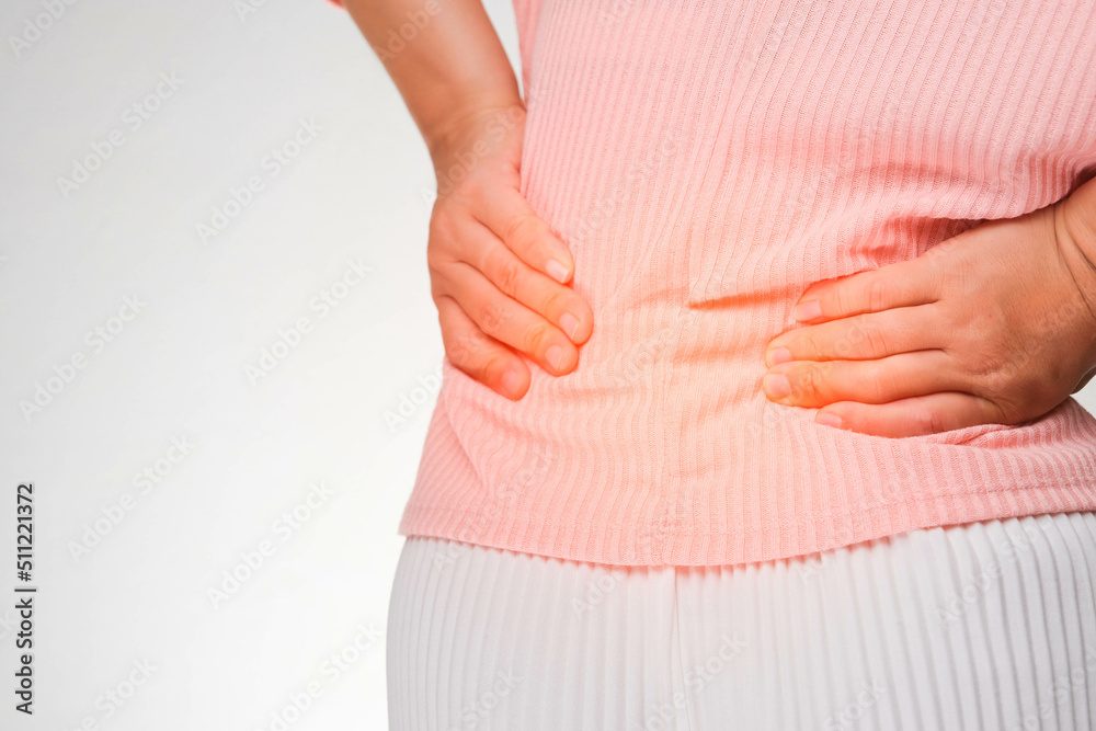 Back view of woman suffering from backache, waist pain, muscle or ...