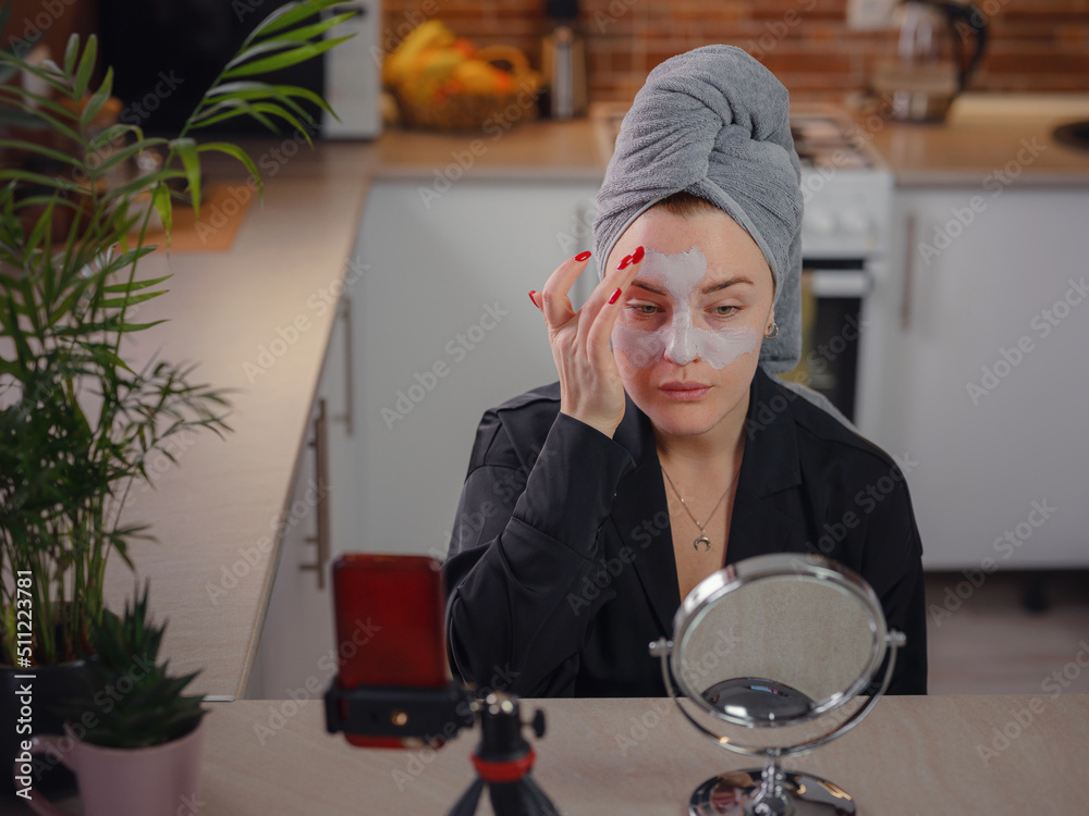 Famous blogger. Cheerful female vlogger showing beauty mask while ...