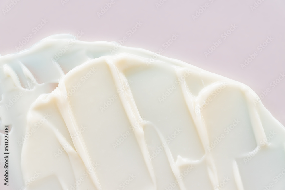 White cream texture on a pastel background. White cream swatch with ...