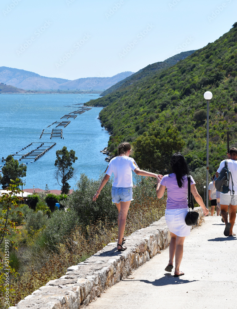 A mother and daughter walking along the curb go to a mussel farm ...