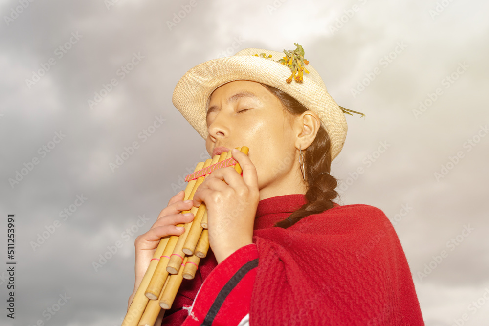 Latin American indigenous woman traditionally dressed playing the ...