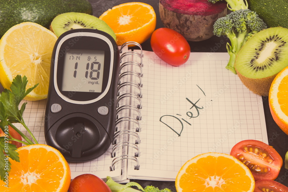 Word diet written in notepad, glucometer and fruits with vegetables ...