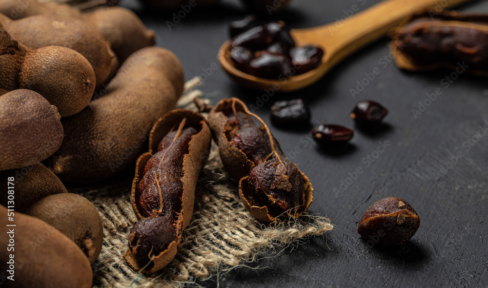 Tropical fruits, Tamarindo beans in shell on a brown butchers block on ...