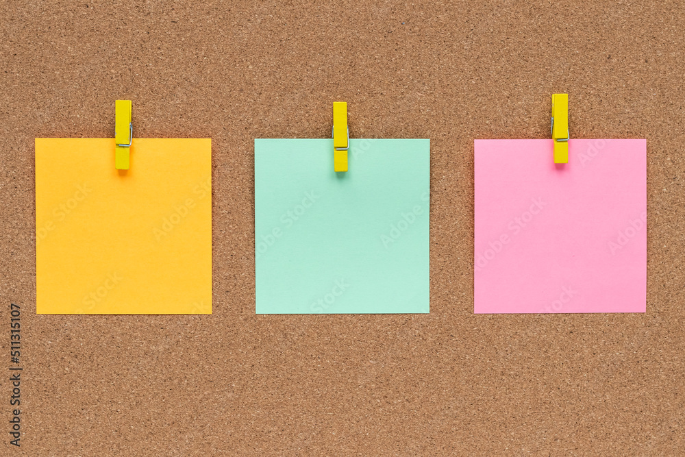 Three multicolor sticky notes on cork bulletin board, reminder ...