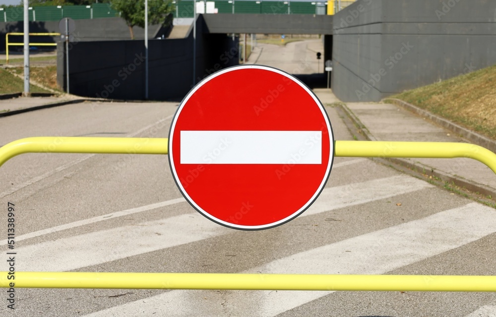 No entry traffic sign on a metallic barrier at the beginning of a road ...