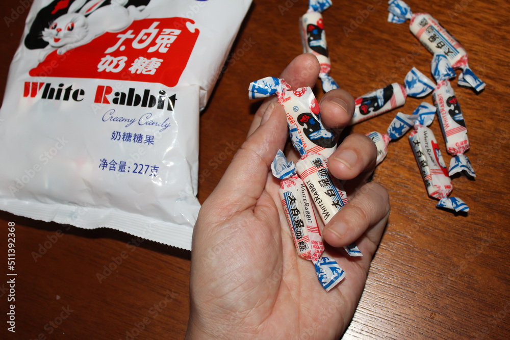 Person holding a single White Rabbit Creamy Candy. This is a brand of ...