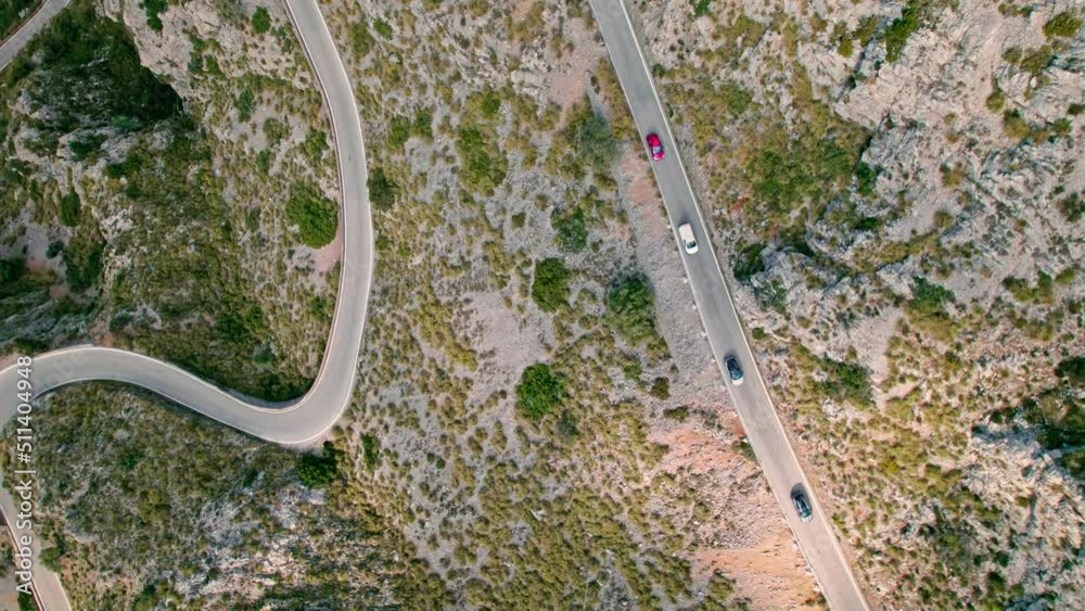 Cars, buses and motorcycles drive on European curved road in Majorca ...