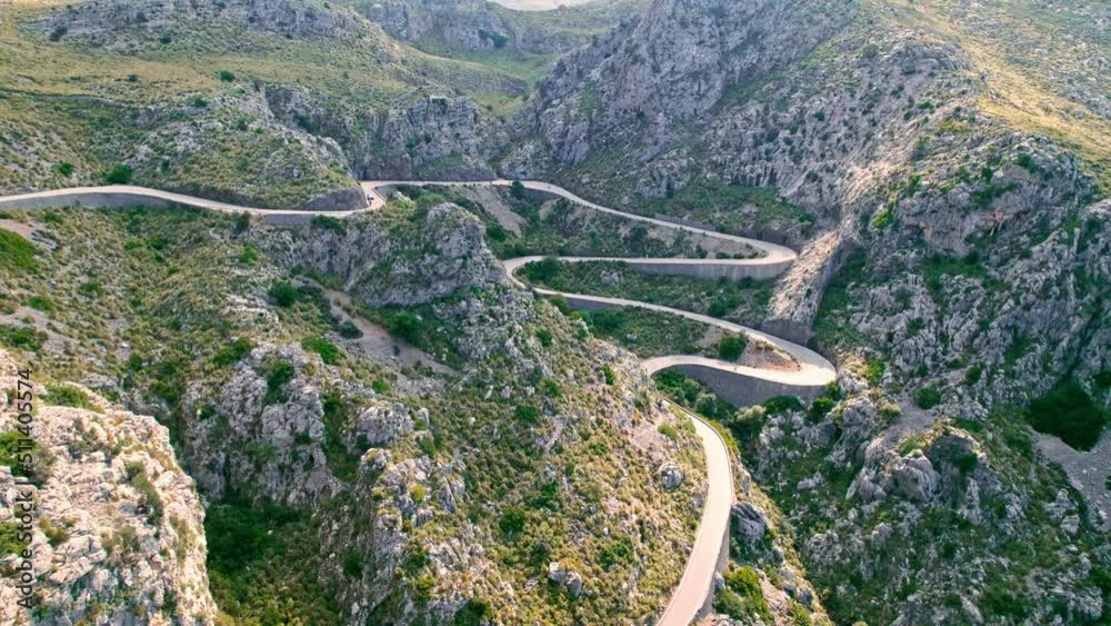 Cars, buses and motorcycles drive on European curved road in Majorca ...