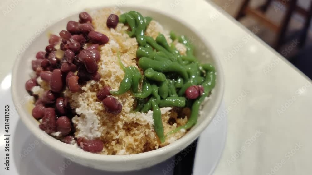 Close-up view of the cendol dessert with gula Melaka syrup. Cendol is ...
