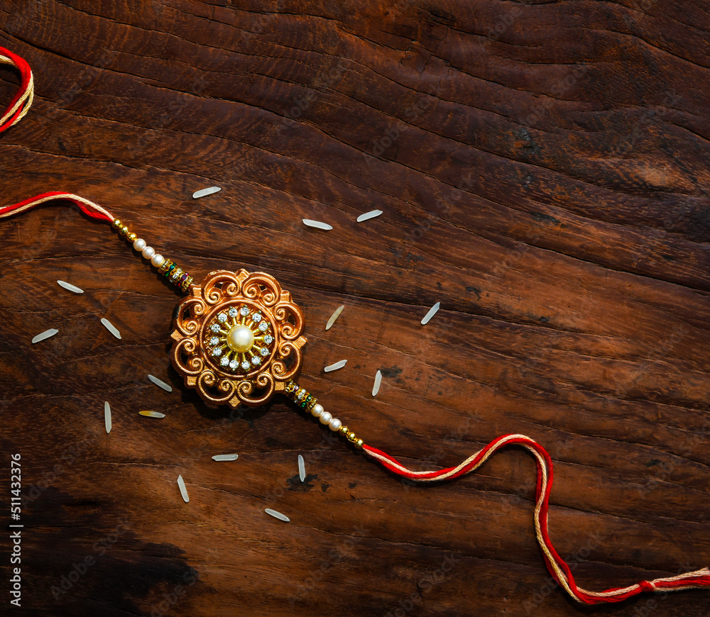 Indian festival: Raksha Bandhan background with an elegant Rakhi, Rice ...