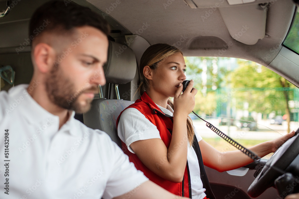 Paramedic answers an emergency call from an ambulance. Young woman ...