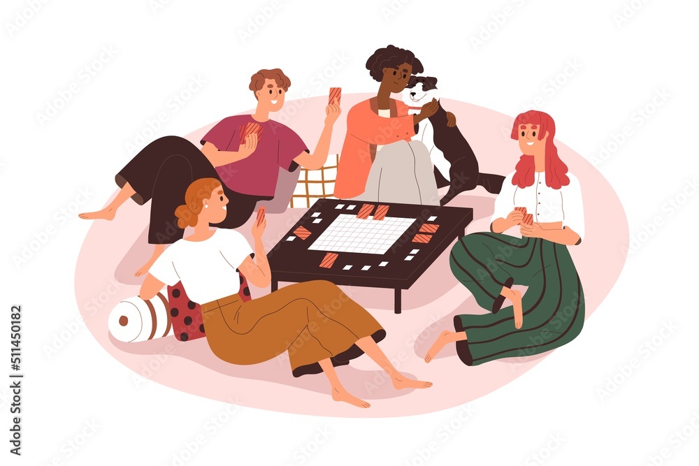 Happy friends playing board game at table together. Young men and women ...