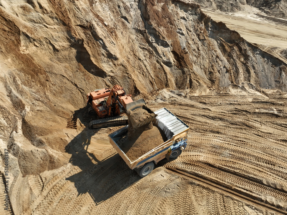 Mining excavator in an open pit during sand mining. Excavator at the development of a sand pit ...