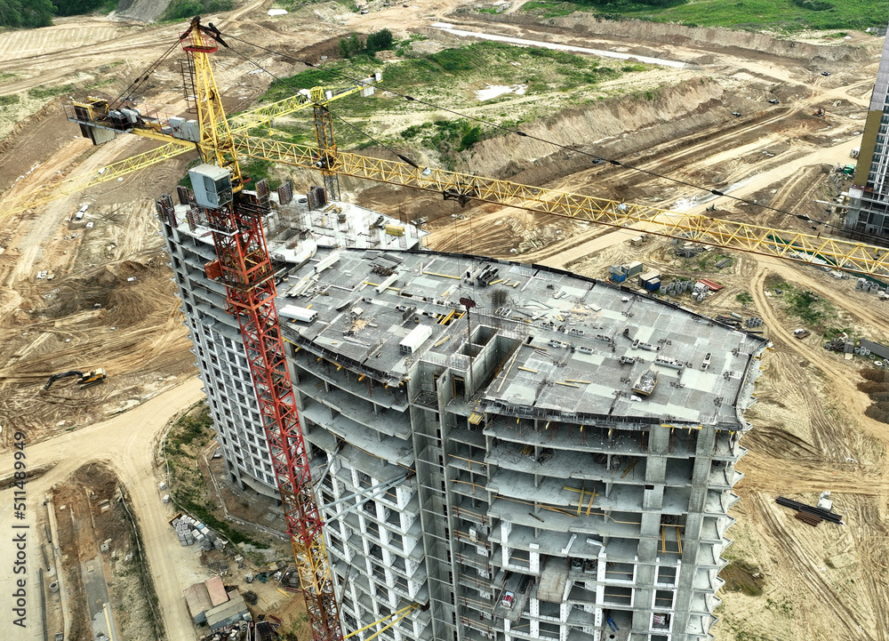 Tower crane on building construction, top view. Builder on formworks ...