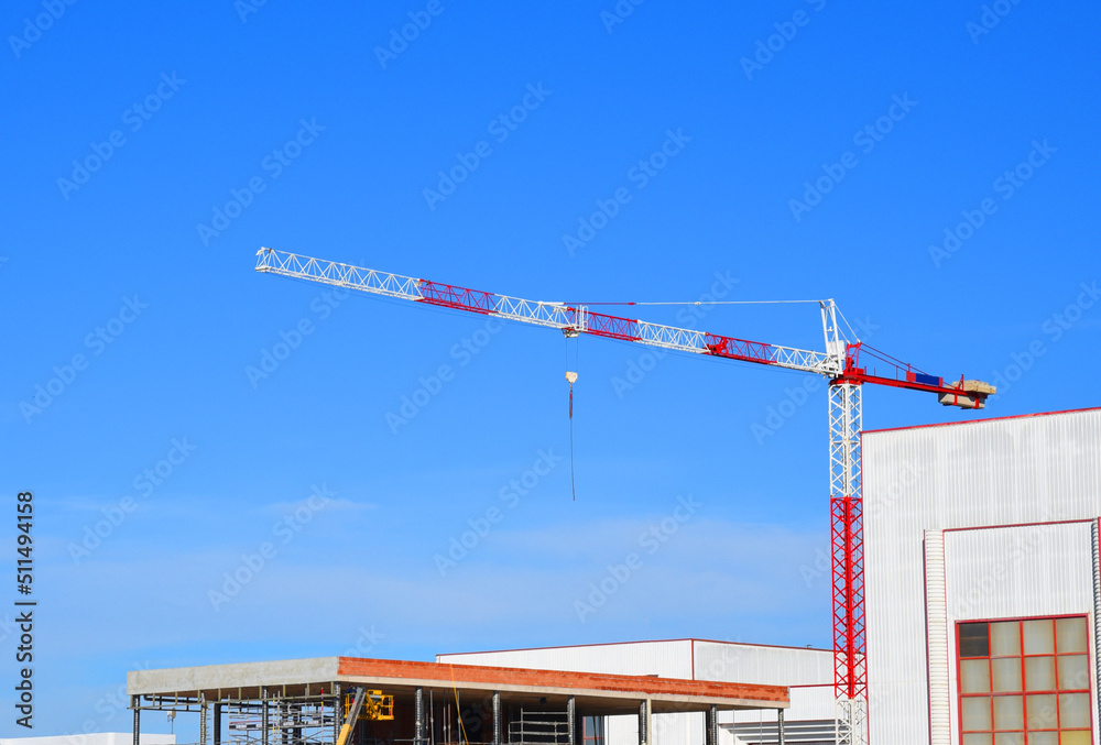 Crane on warehouse conctruction. Tower cranes in action a building ...
