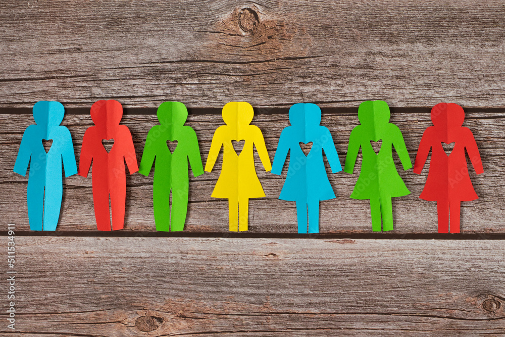 Human cut from paper in a row showing women and men who hold their ...