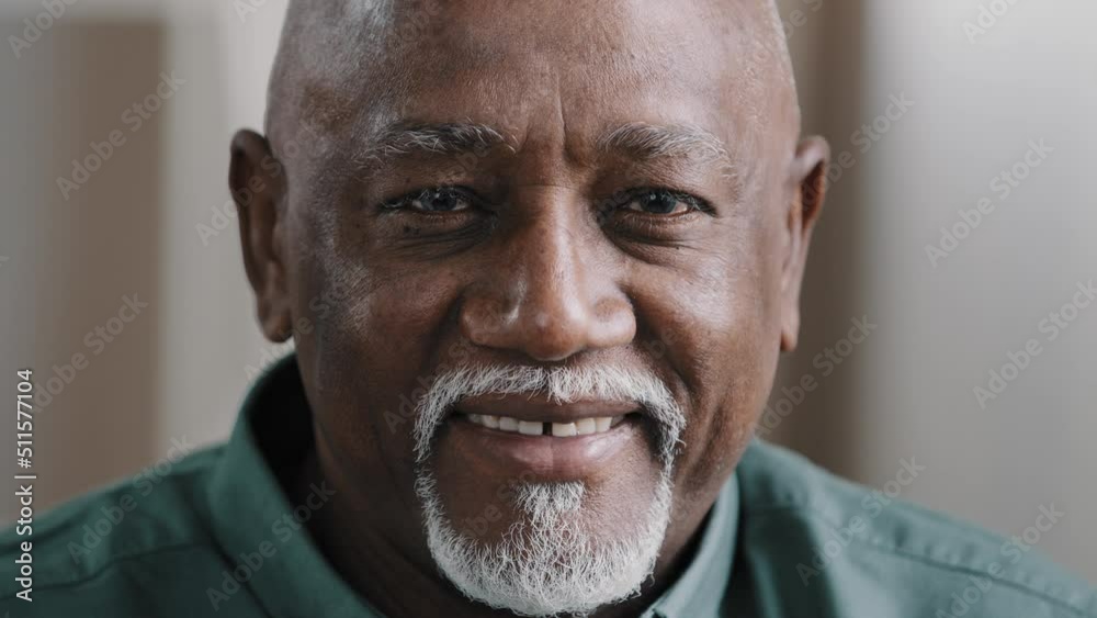 Extreme close up happy smiling old wrinkled male face. African ...