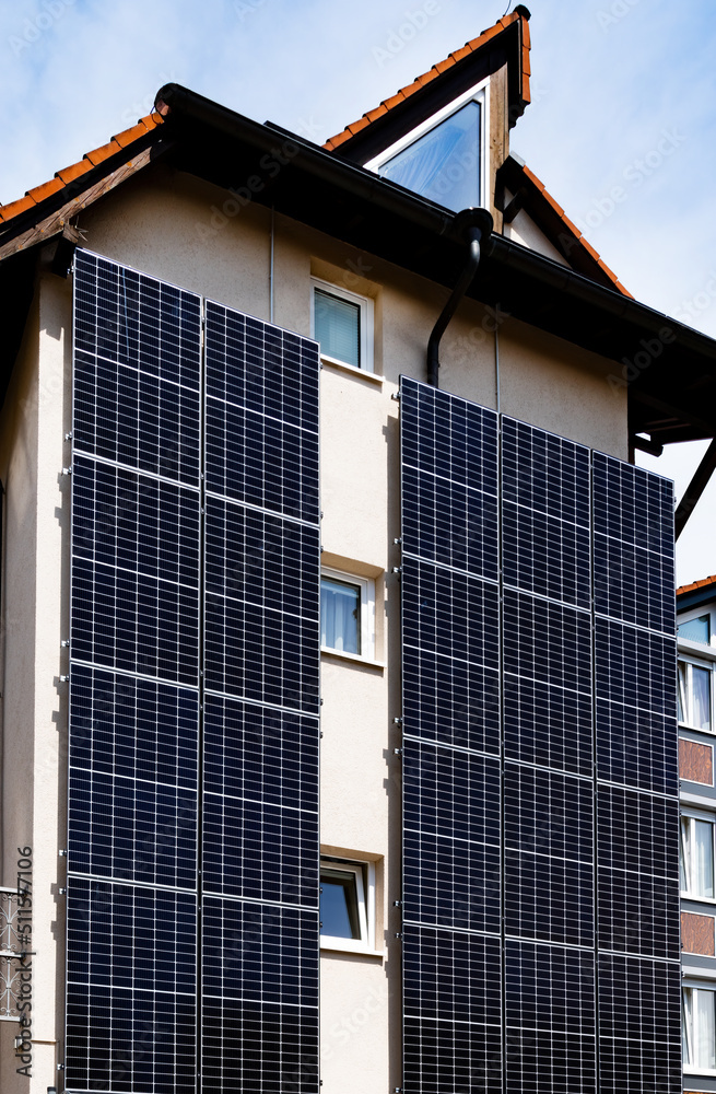 Building with vertical solar panels on a facade Stock Photo | Adobe Stock