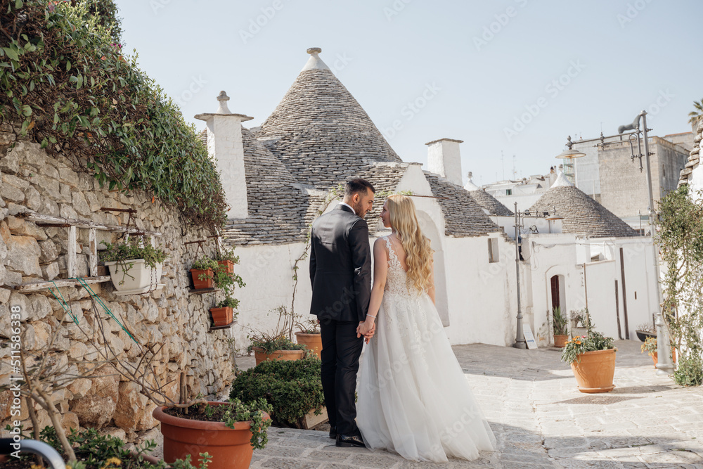 Romantic married couple, woman in white wedding dress and man in black ...