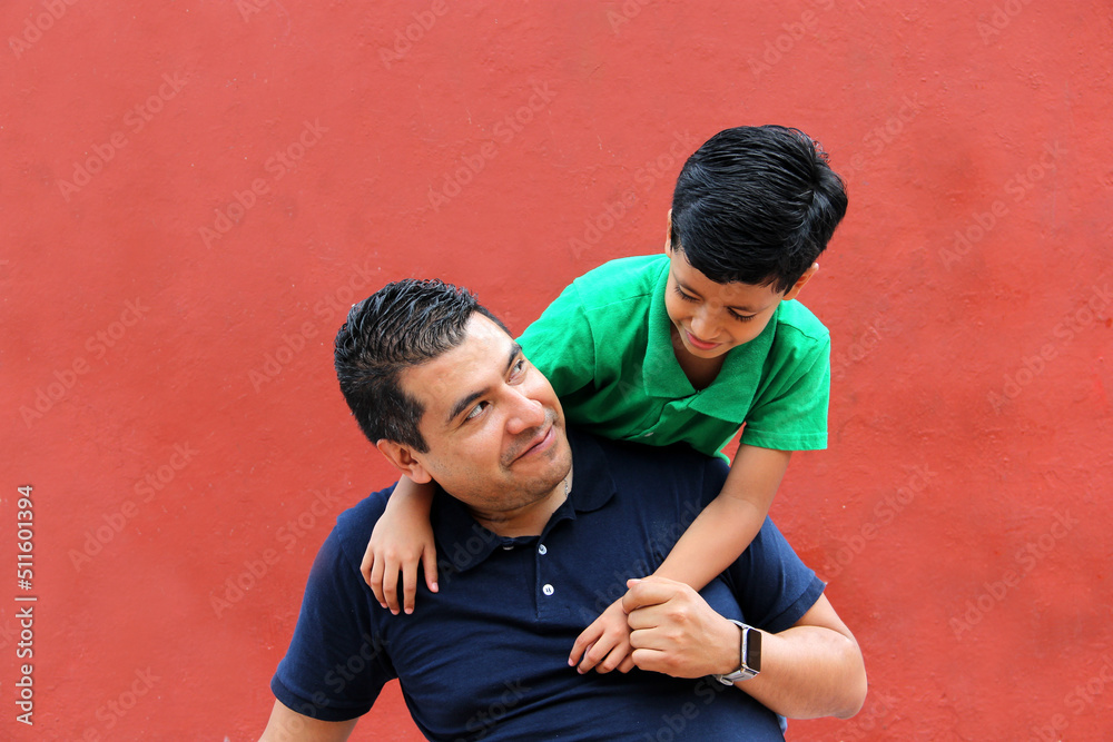 Single dad and dark-haired Latino son play and have fun together ...