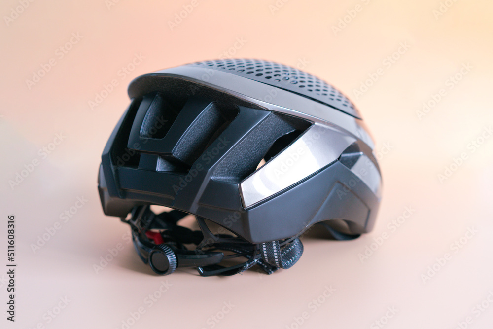 Back view of black and grey bicycle helmet on a yellow background ...