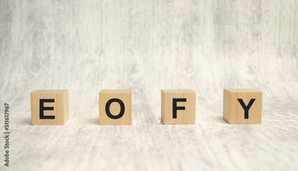 EOFY, End of Financial Year text. wood cubes and white background Stock ...