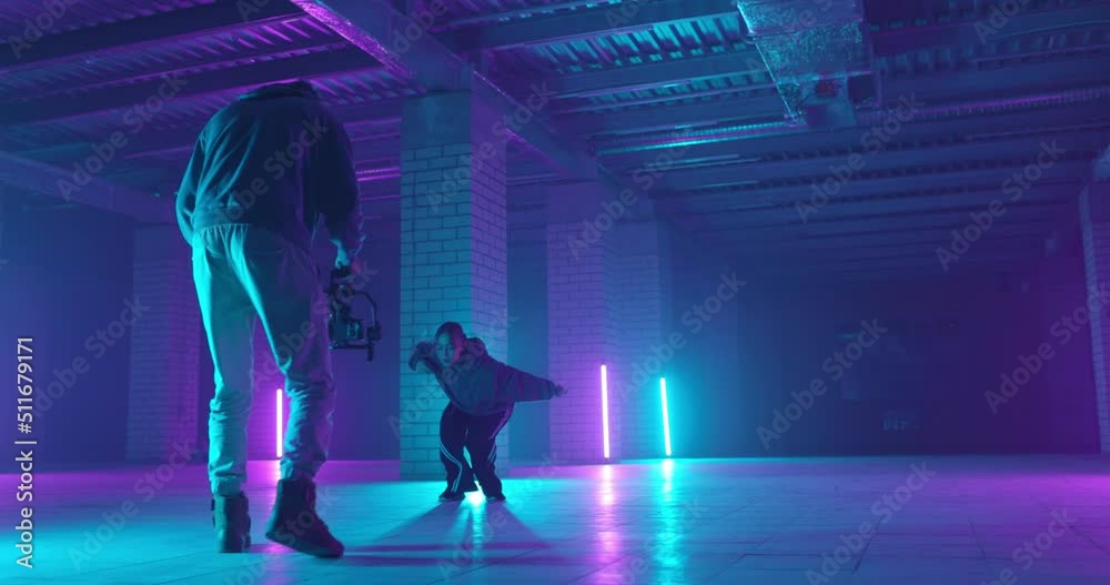 Backstage of video clip shooting. Cameraman filming hip-hop dancers in ...