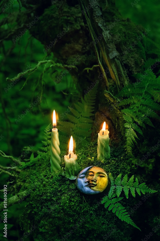 candles and symbol of moon on dark forest natural background. pagan ...