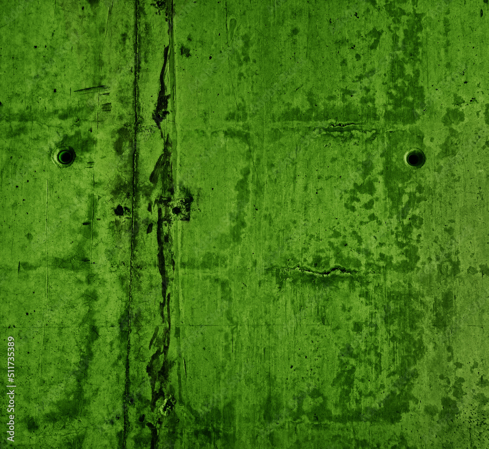 green raw concrete wall with concrete form dimples, grid lines and dark ...
