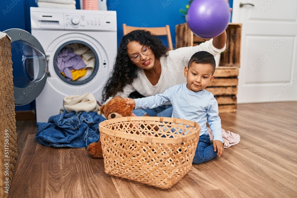 Mother and son smiling confident washing clothes at laundry room Stock ...