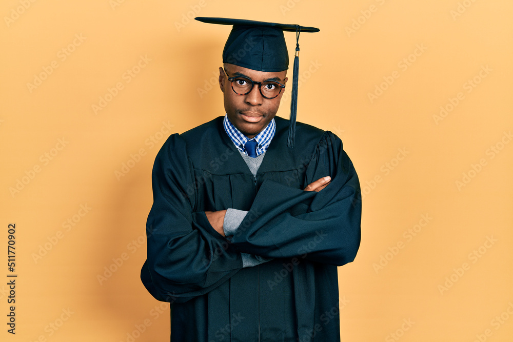 Young african american man wearing graduation cap and ceremony robe ...