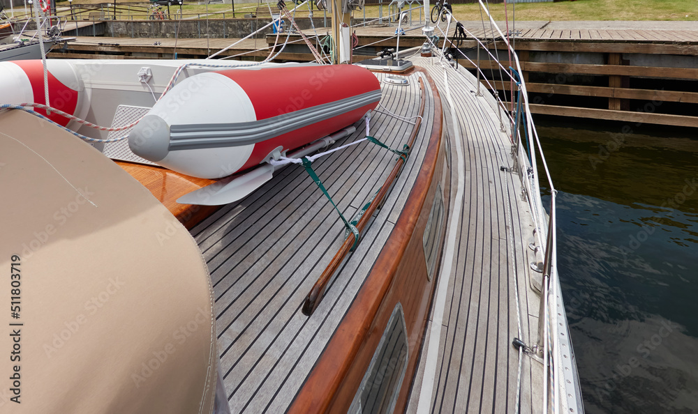 An elegant two masted sailboat (ketch) moored to a pier in a yacht ...