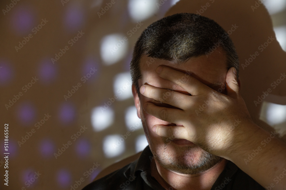 A man covered his face with his hand. Portrait of a middle-aged man ...