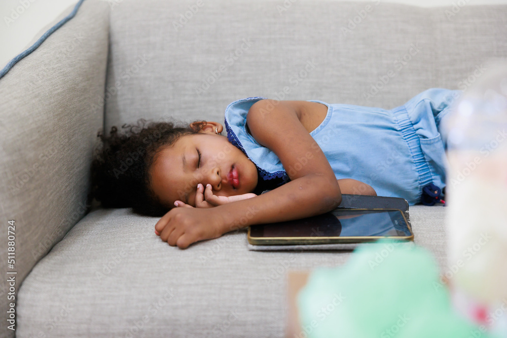 Portrait african american kid girl sleeping on sofa bed at home. Stock ...