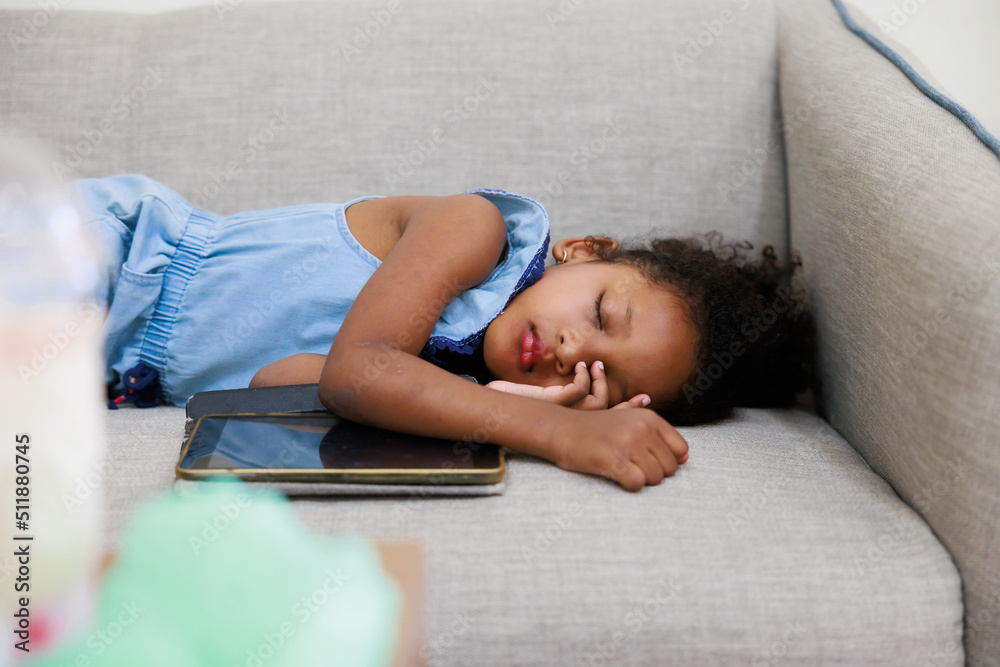 Portrait african american kid girl sleeping on sofa bed at home. Stock ...
