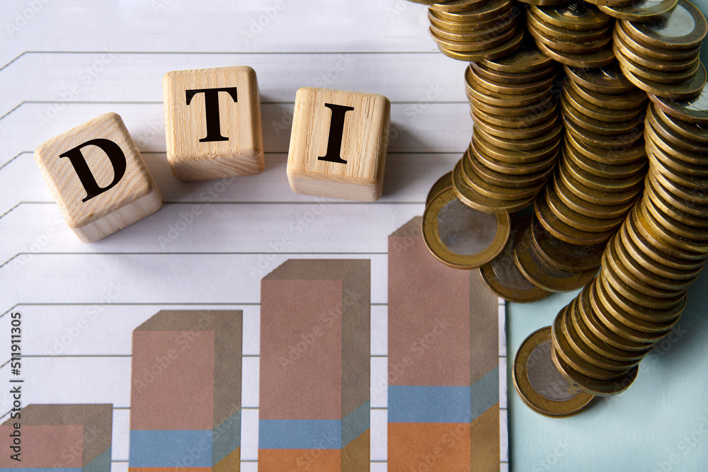 DTI - acronym on a green sheet on the background of a graph, pencils ...