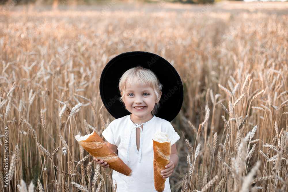 Beautiful portrait of a young child in a field. Children with bread ...