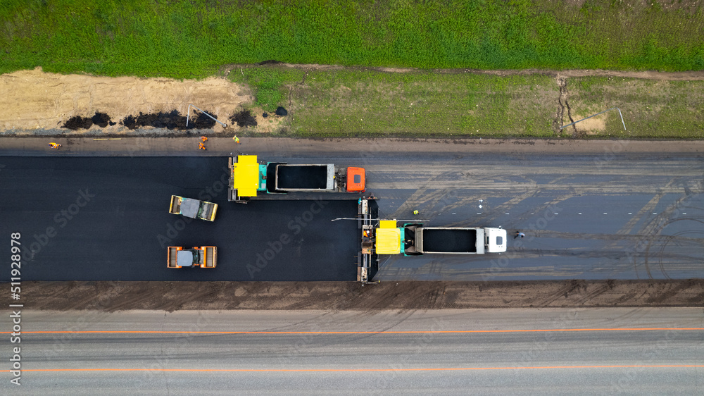 Road construction works aerial view. Laying of new asphalt on the road ...