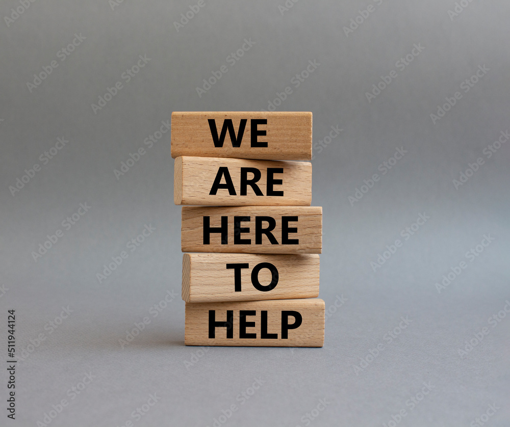 We are here to help symbol. Concept words we are here to help on wooden ...