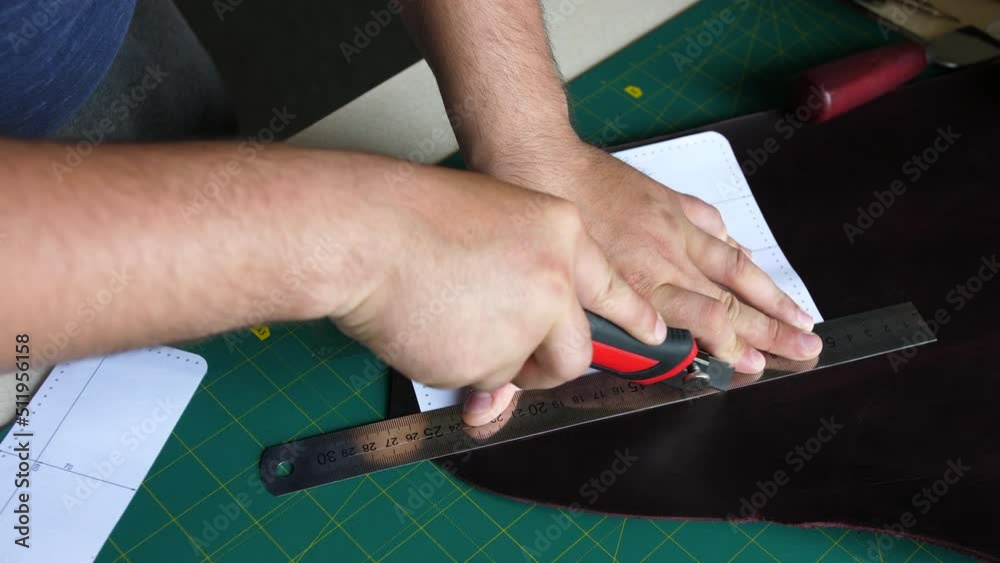 The man cut a large piece of skin with a stationery knife. The knife ...