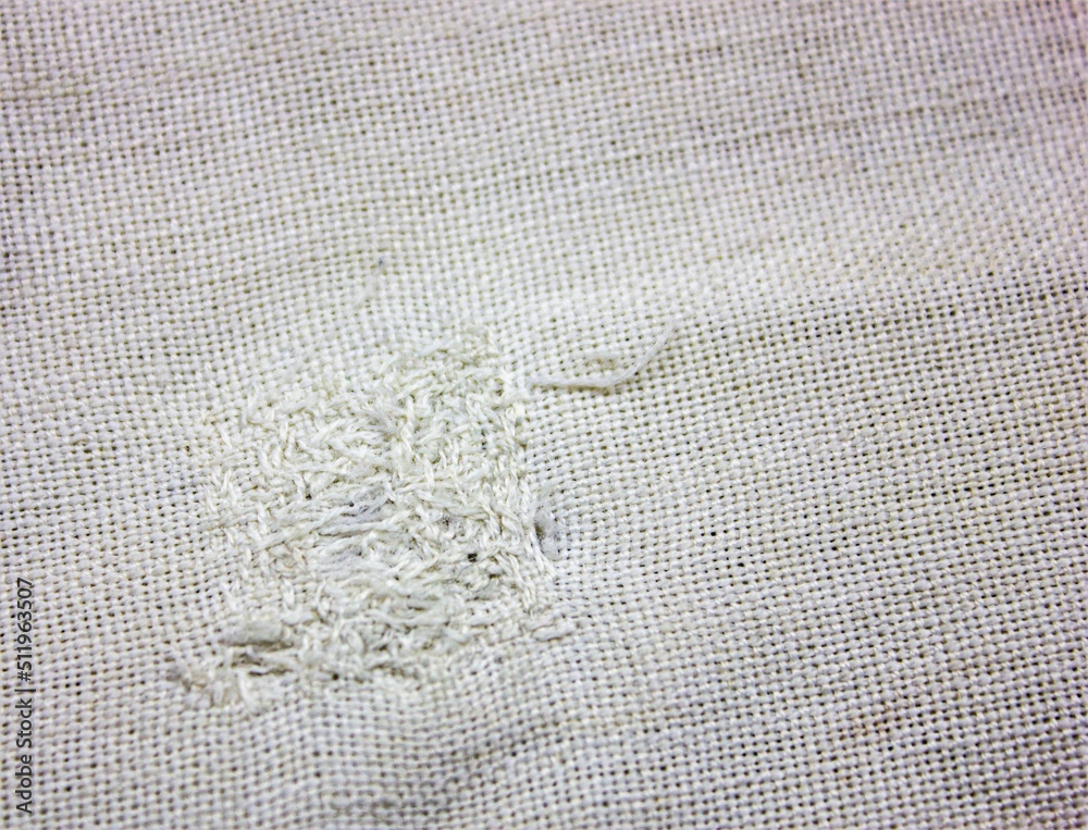 Sewn hole close-up.Sewn old fabric.Patch with threads.The Old torn ...