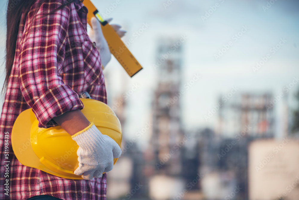 Woman construction engineer wear safety white hard hat at construction ...
