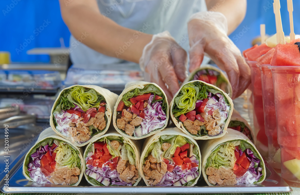 Wraps stuffed with meat and vegetables prepares for sale to the ...